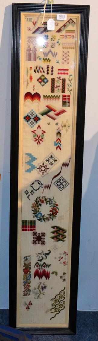Lot 1063 - Late 19th century wool work long sampler,