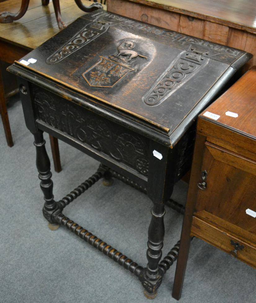 Lot 1401 - A carved oak bible box on stand composed of