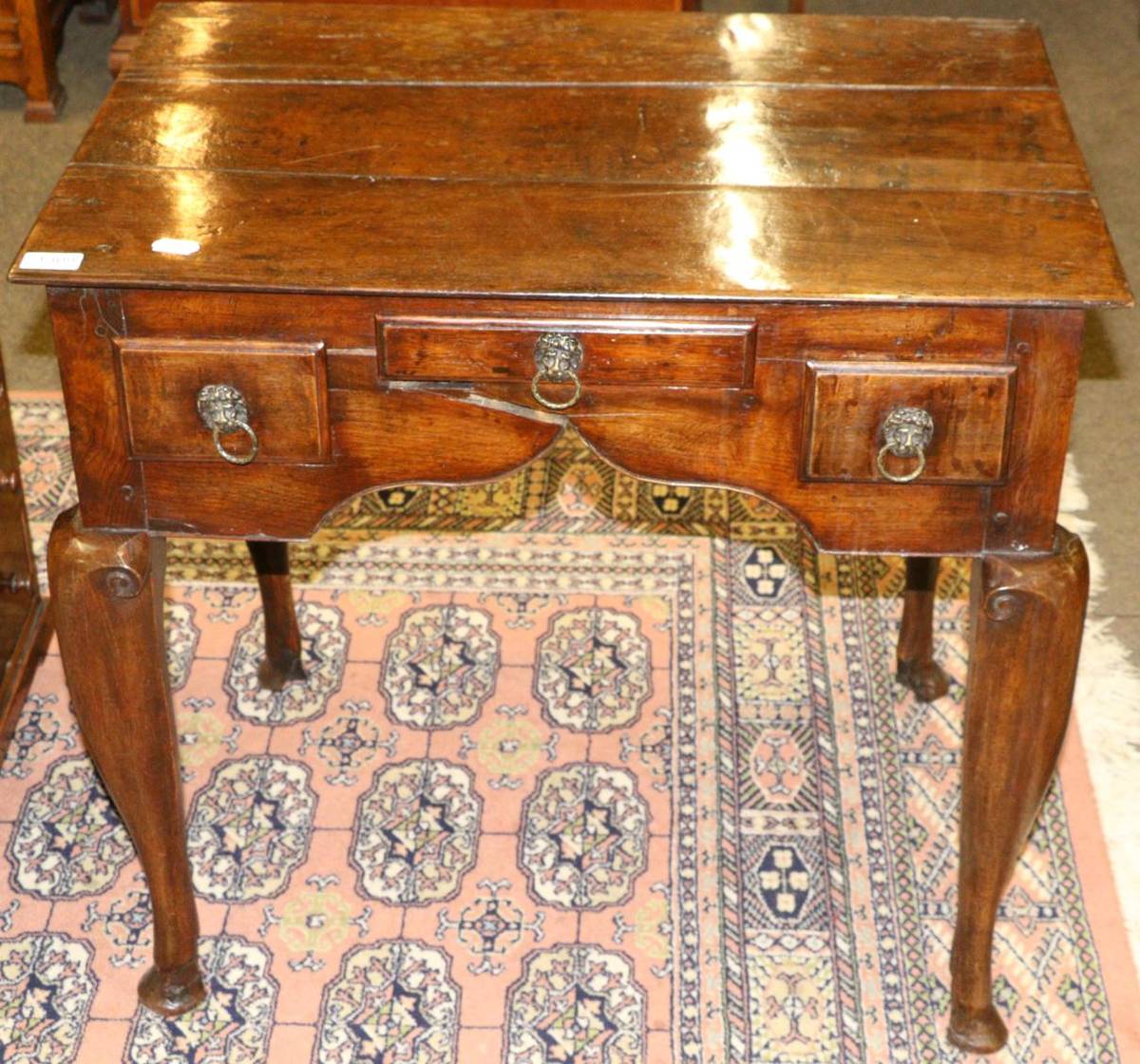 Lot 1309 - An 18th century oak lowboy with three