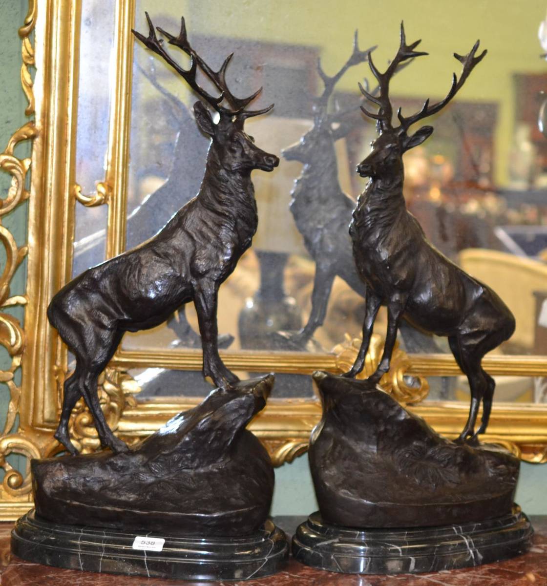 Lot 538 - A pair of bronzed stag models, each signed,
