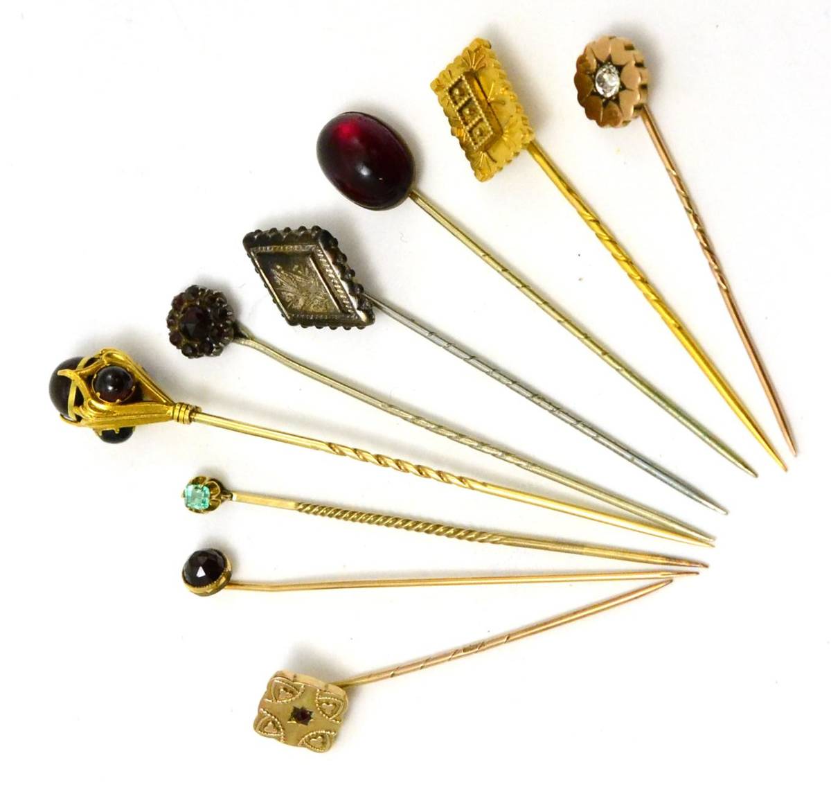 Lot 403 - A group of sixteen stick pins, some cased,