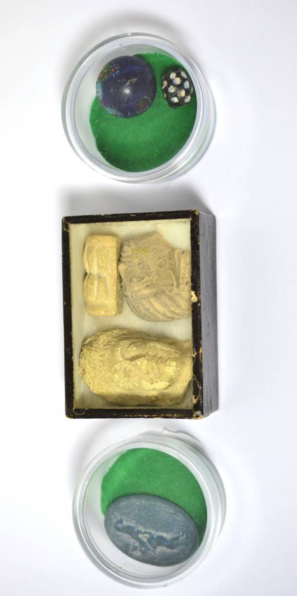 Lot 99 - An Egyptian core formed dark blue glass bead,