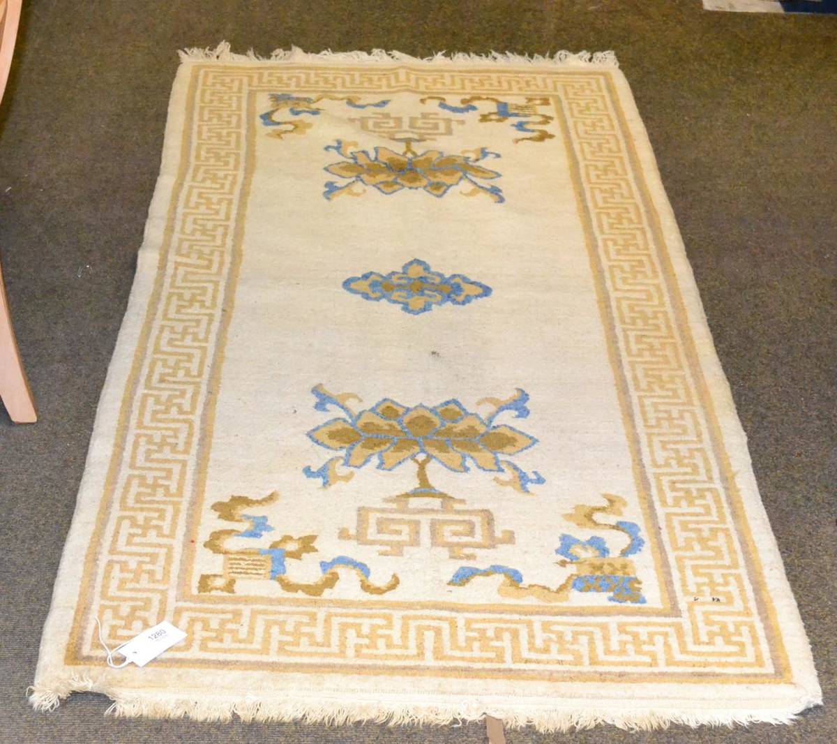 Lot 1280 - A Tibetan/Nepali rug, the cream field with