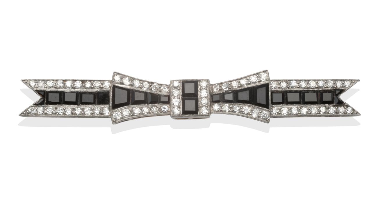 Lot 277 - An Art Deco Onyx and Diamond Bow Brooch, the