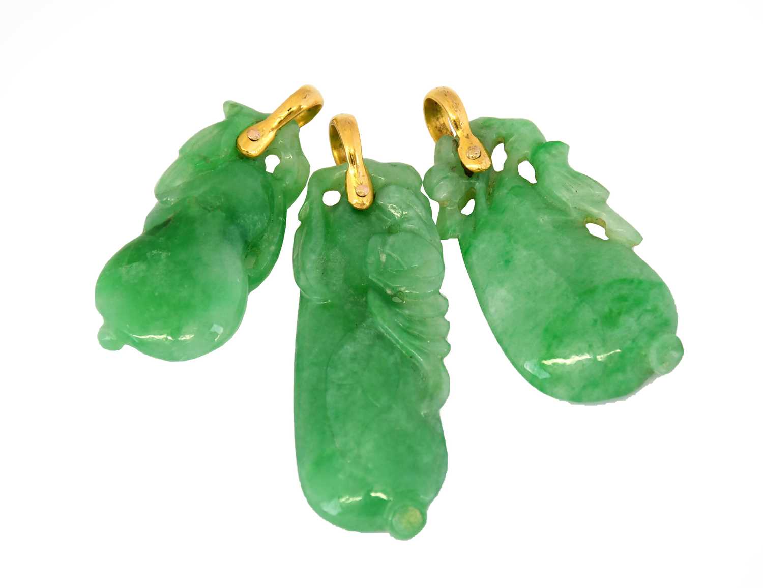 Lot 1085 - Three jade pendants, each pierced pendant