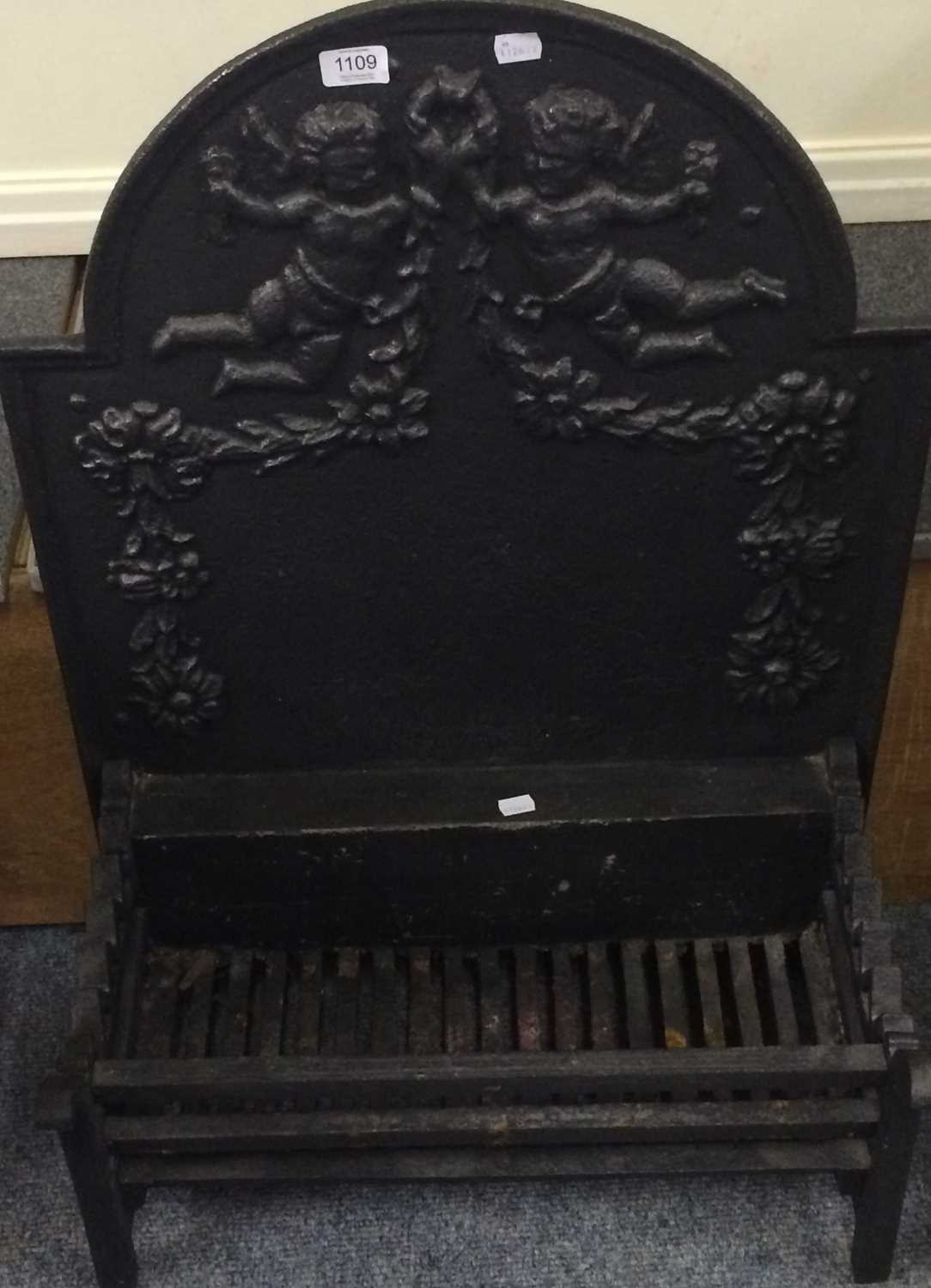 Lot 1109 - A cast iron fire grate and back decorated