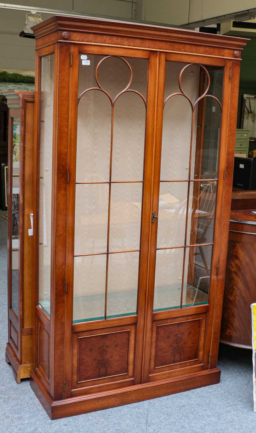 Lot 1399 - A reprodux walnut display cabinet with