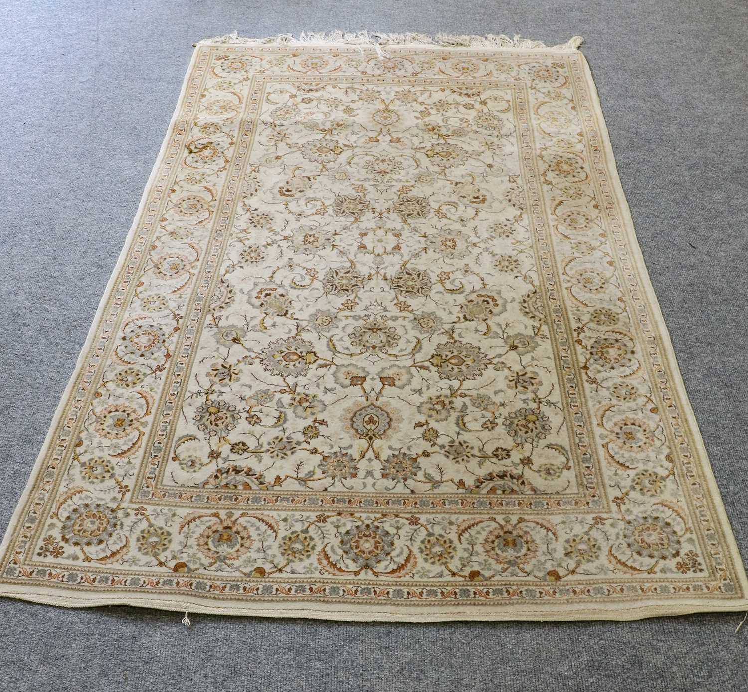Lot 1090 - A Kashan rug, the ivory field with an all