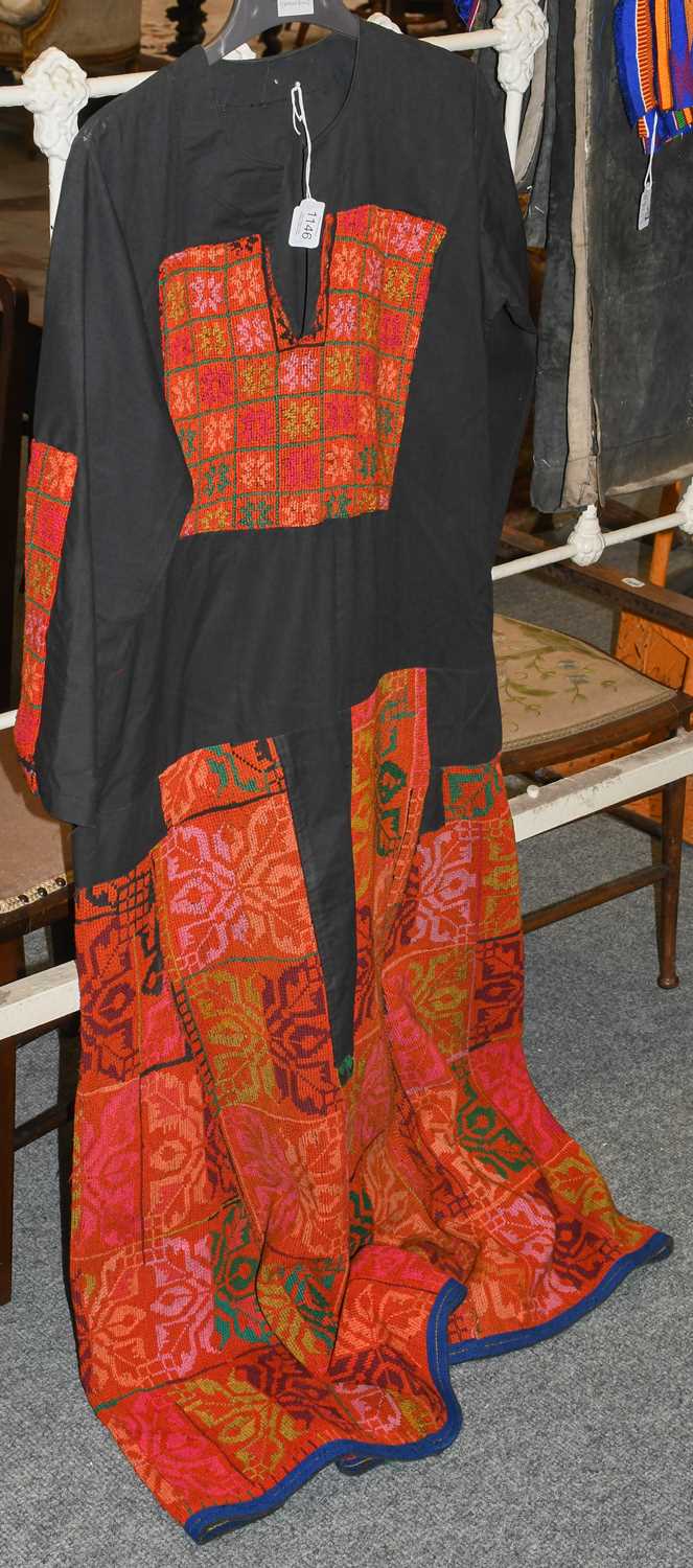 Lot 1146 - Black cotton eastern tunic with red cross