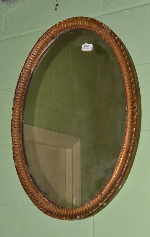 Lot 389 - George III oval carved giltwood mirror,