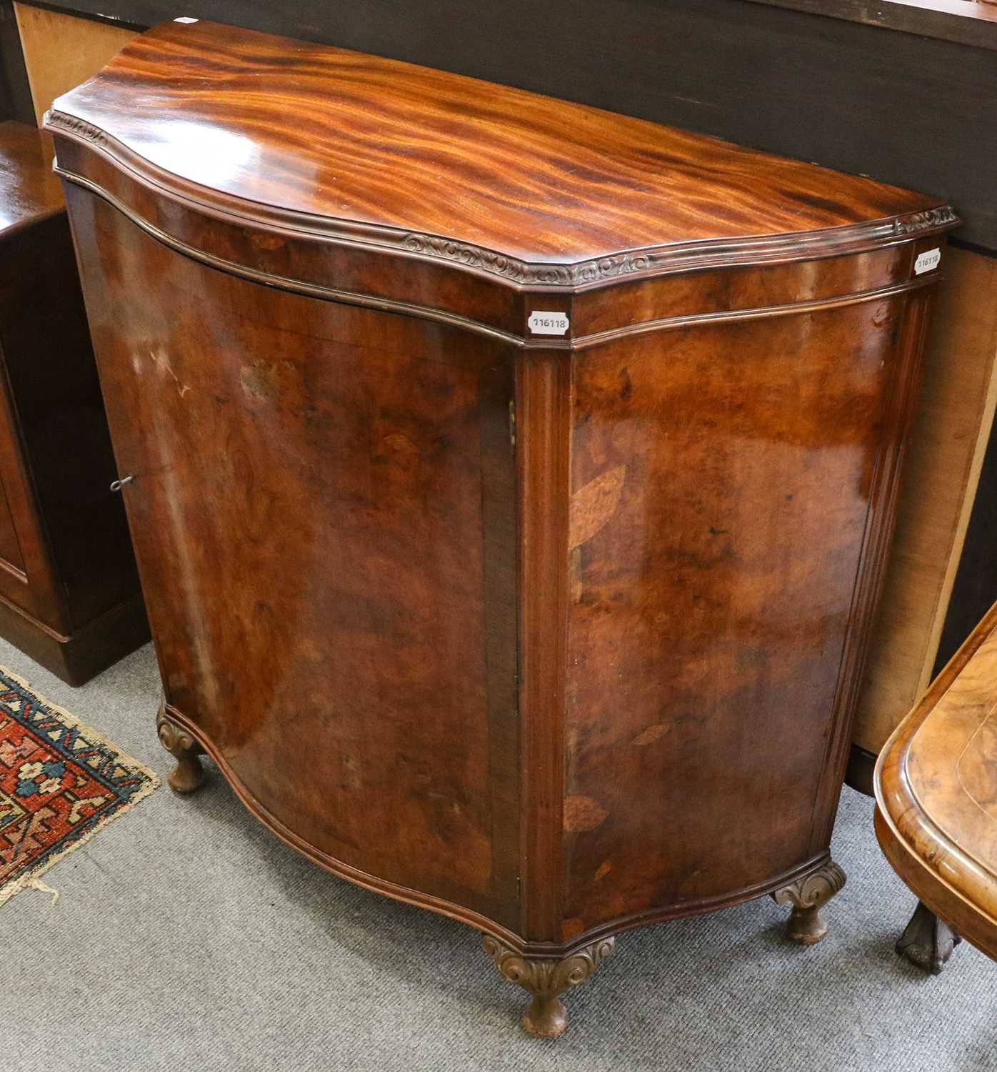 Lot 1168 - A reproduction walnut serpentine fronted