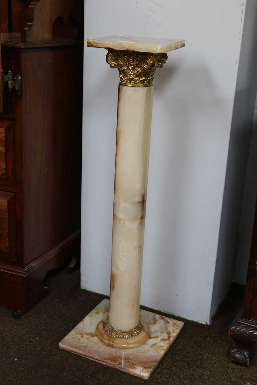 Lot 1225 - An Onyx and Gilt Metal Torchere, of