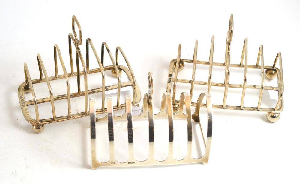 Lot 332 - Three various silver toast racks