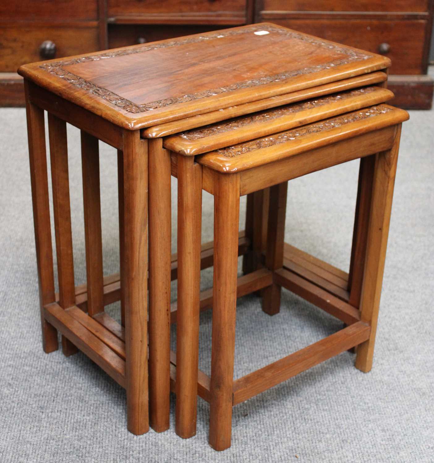 Lot 1239 - A Nest of Four Carved Teak Tables, largest,