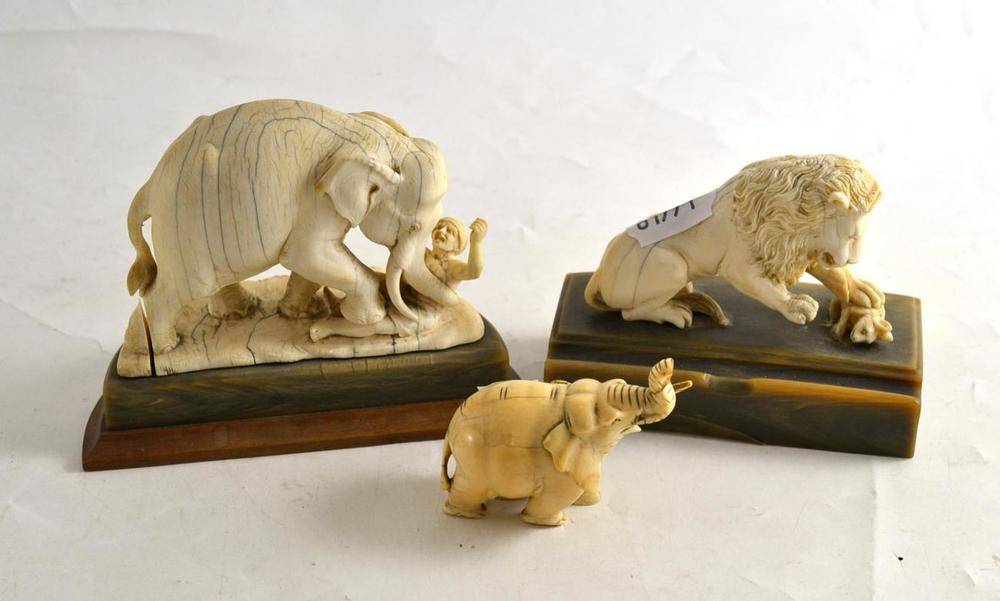 Lot 392 - An Indian ivory elephant, a lion on horn