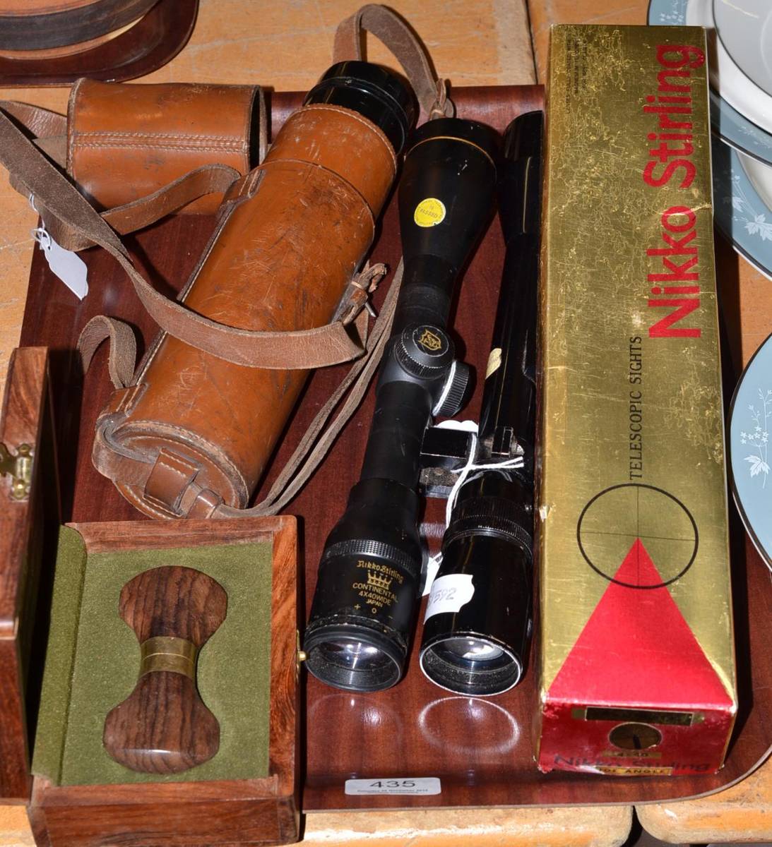 Lot 435 - A leather cased telescope, three gun sights