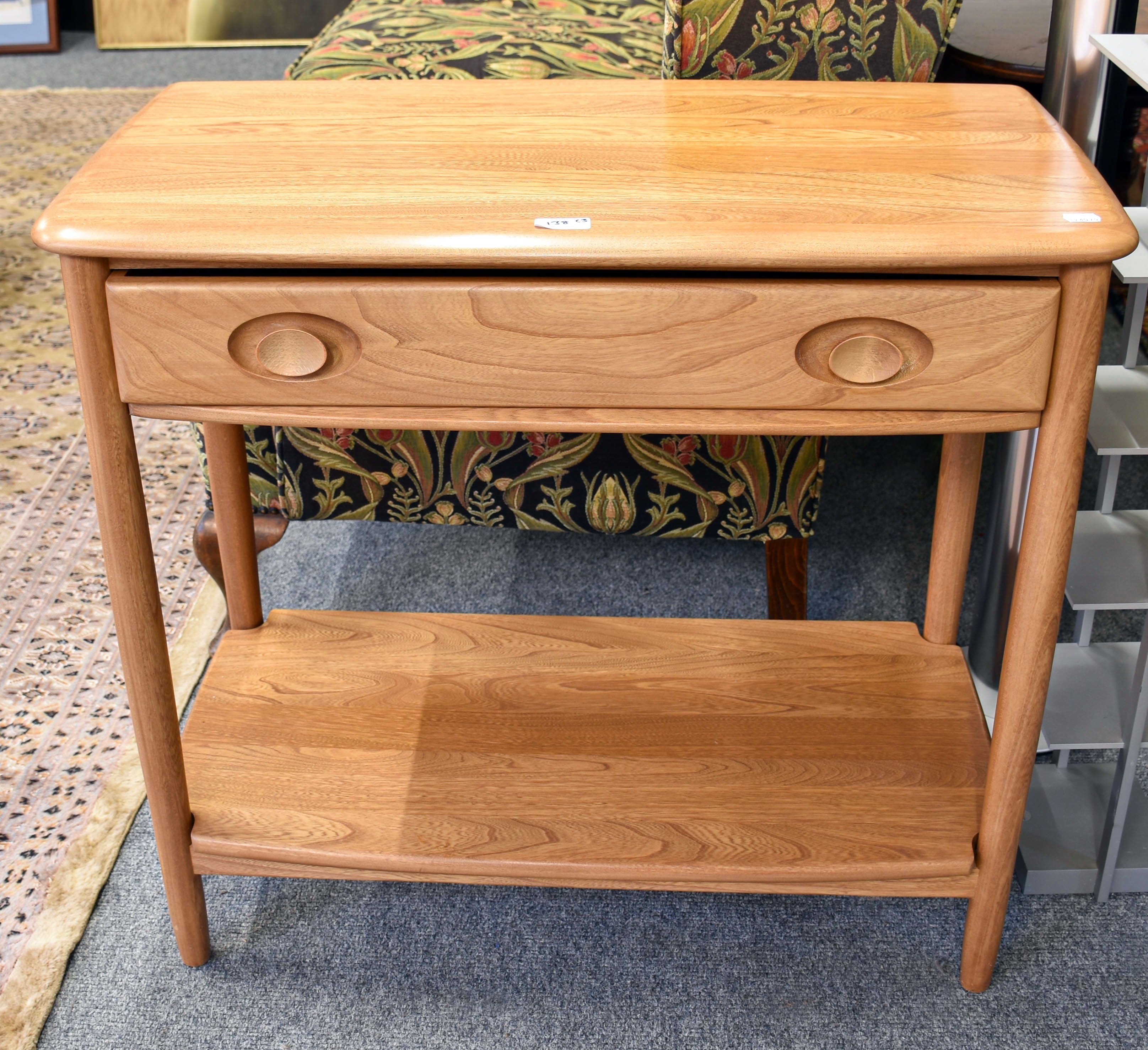 Lot 138 - An Ercol Windsor Light Elm Finish Hall Table,