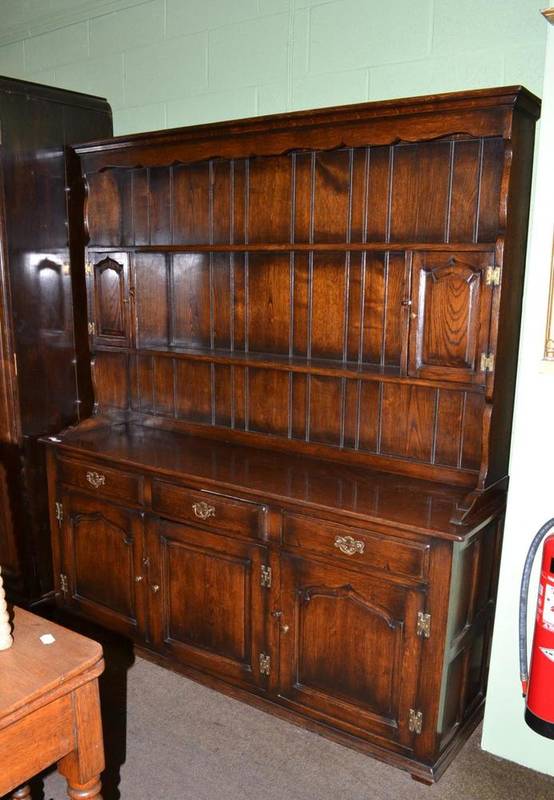 Lot 480 - A reproduction oak enclosed dresser with