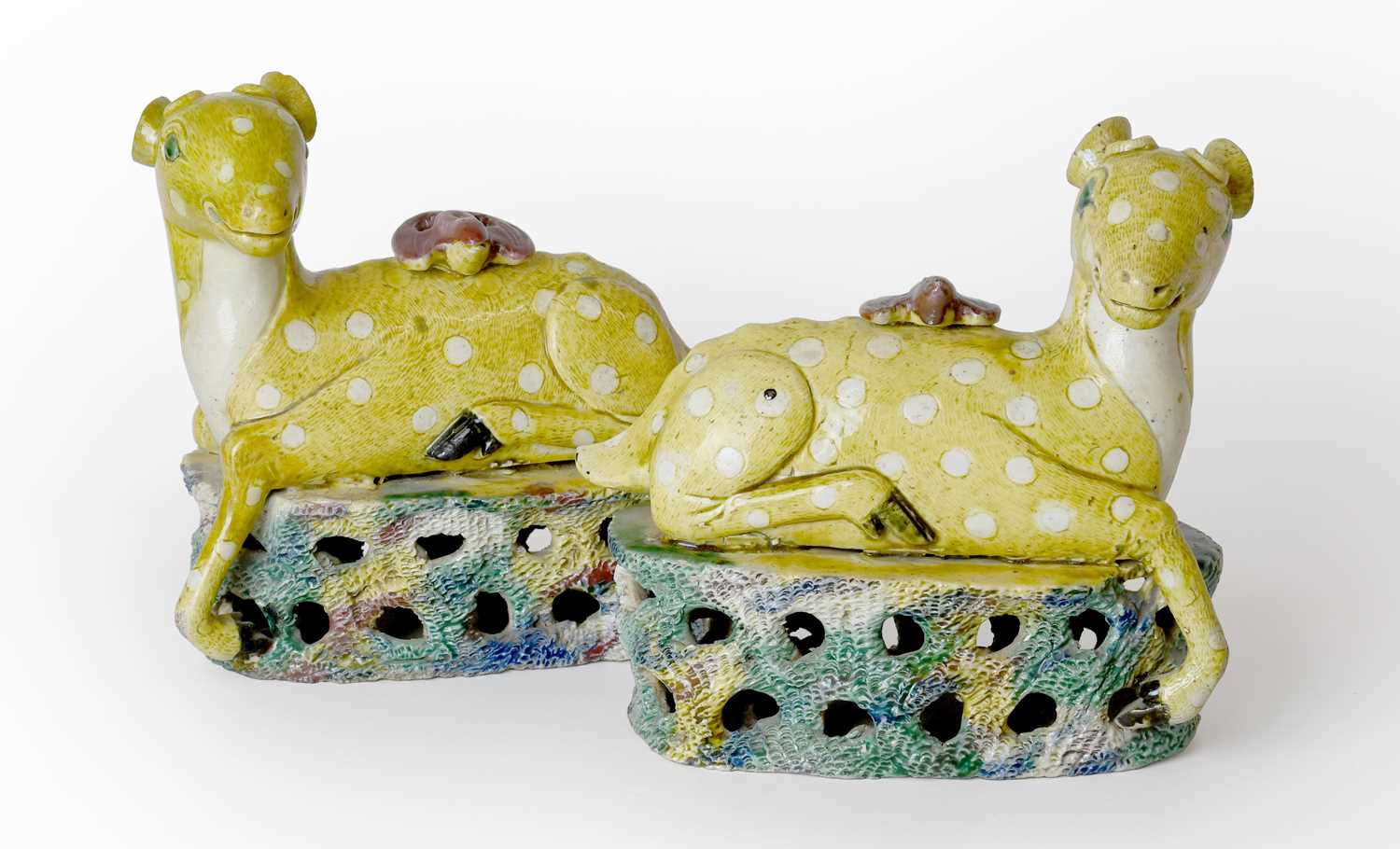 A Pair of Chinese Porcelain Models of Recumbent Deer,