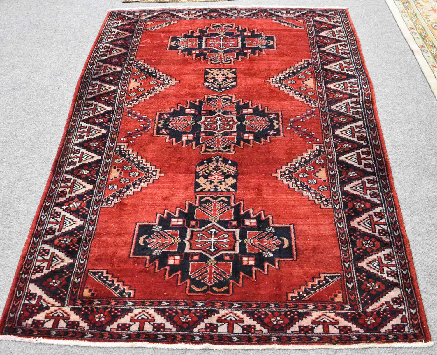 Lot 1001 - Kolyai Rug, the burgundy field with three