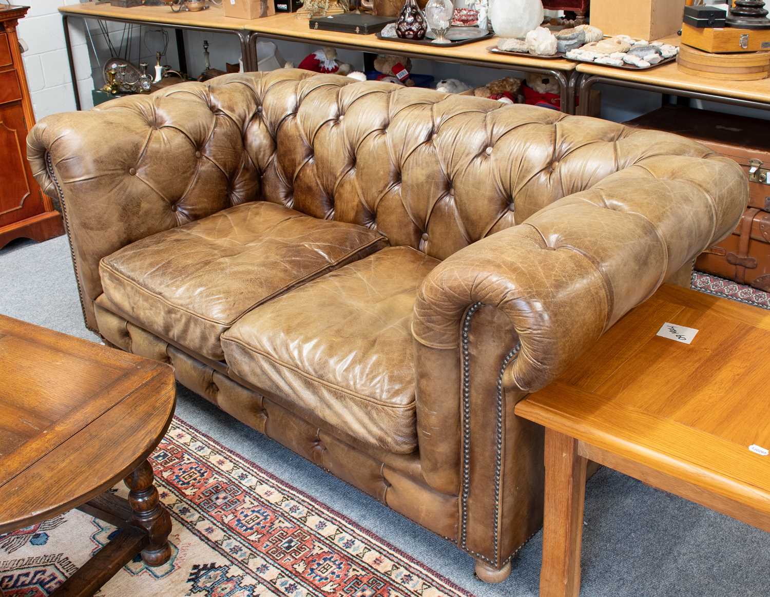 Lot 1142 - A Brown Leather Chesterfield Sofa by