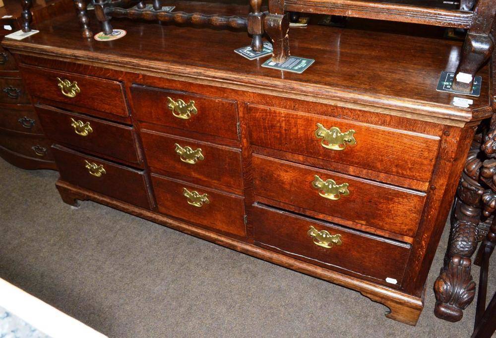 Lot 679 - A Georgian oak sideboard base with six
