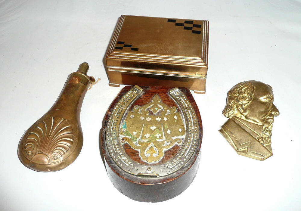Lot 180 - Powder flask, brass games compendium, relief