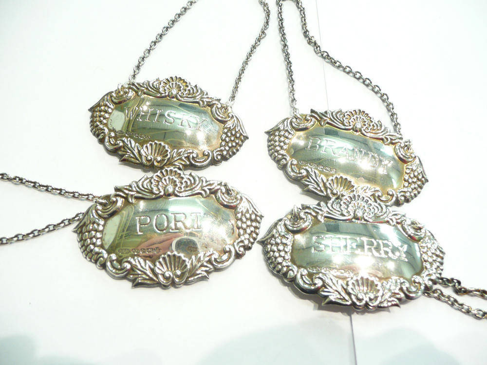 Lot 222 - Four silver wine labels, boxed