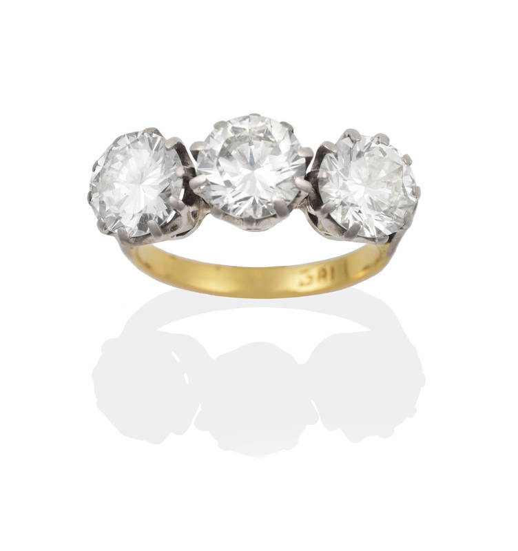 Lot 99 - A Diamond Three Stone Ring, the round