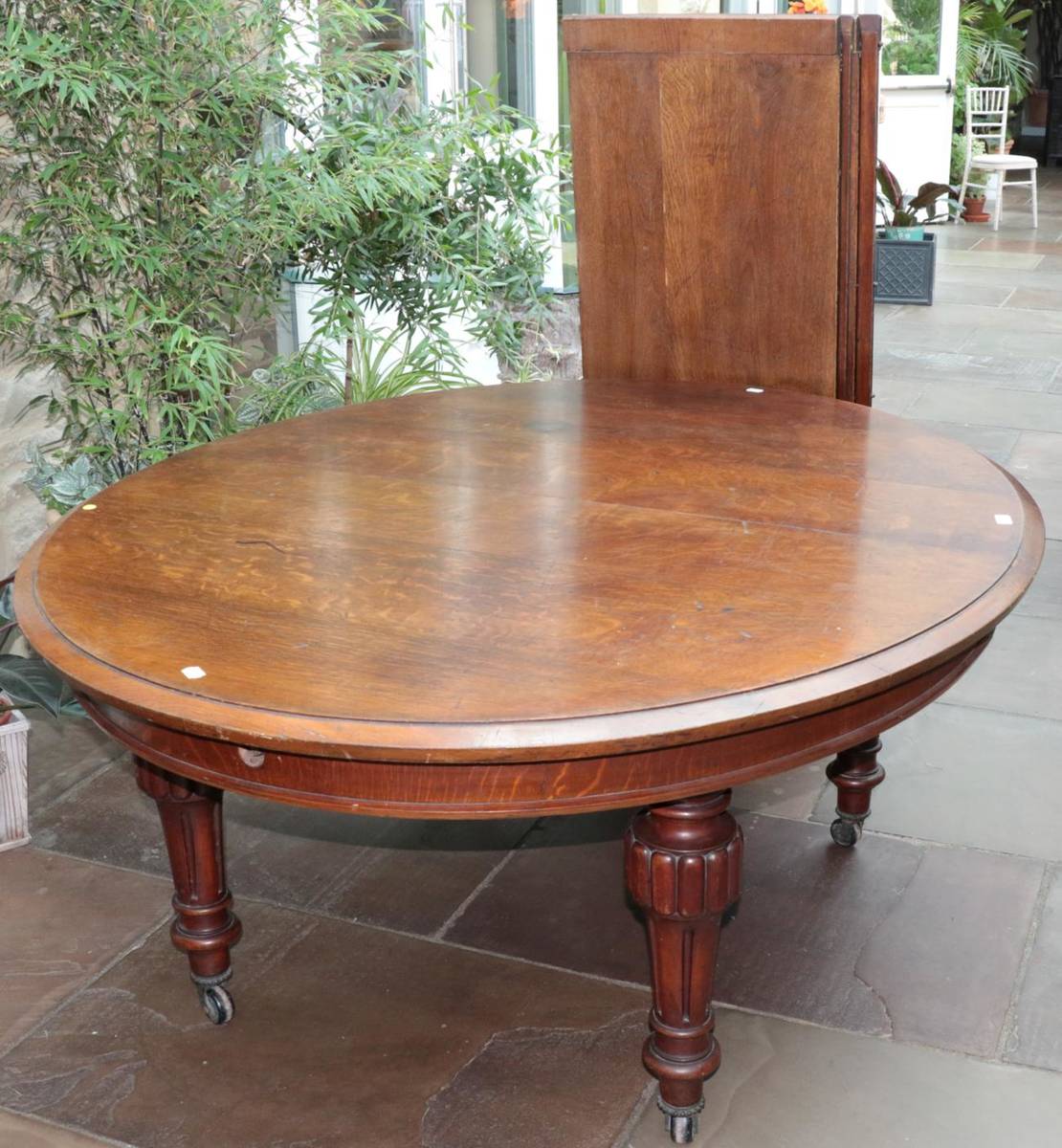 Lot 1811 - A Victorian Oak Oval Extending Dining Table,