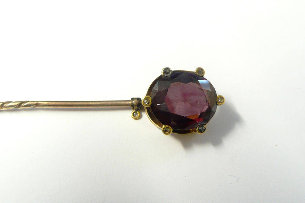 Lot 339 - A Garnet and Diamond Stick Pin, an oval cut