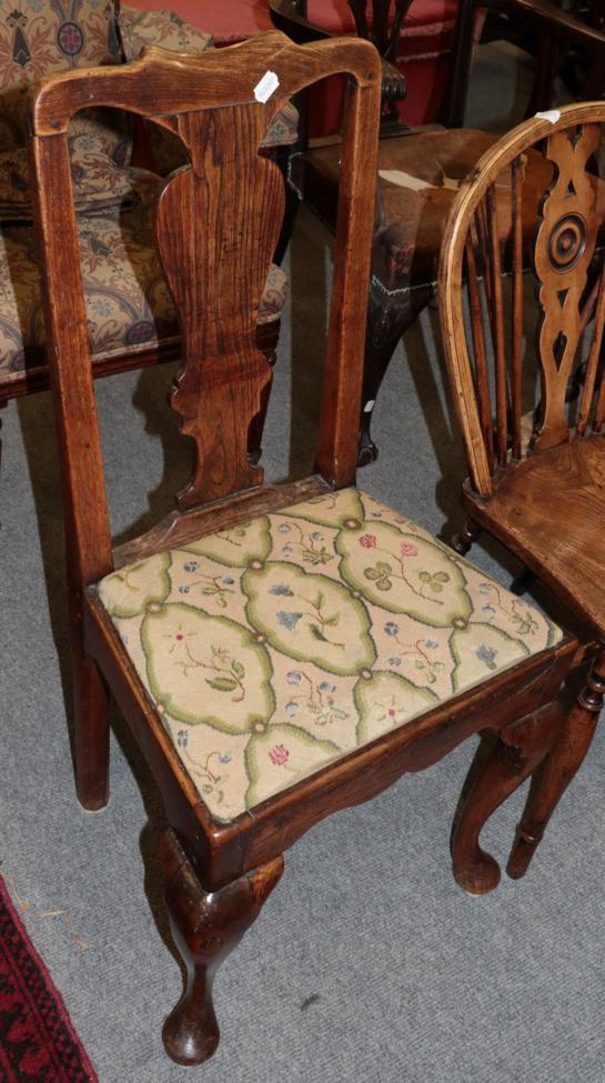 Lot 1294 - An early 18th century elm country chair,