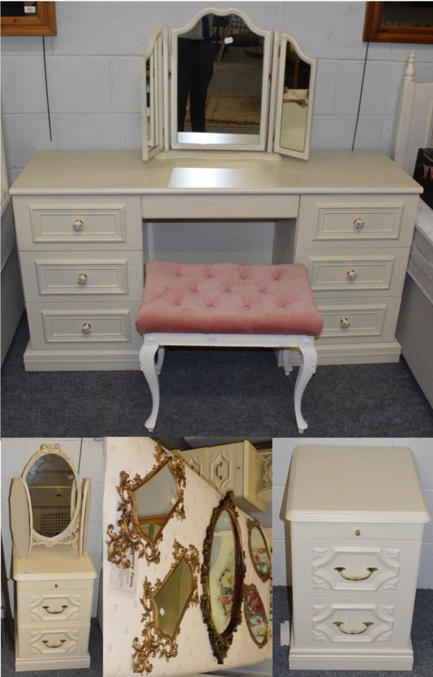 Lot 564 - A cream dressing table with six drawers; two