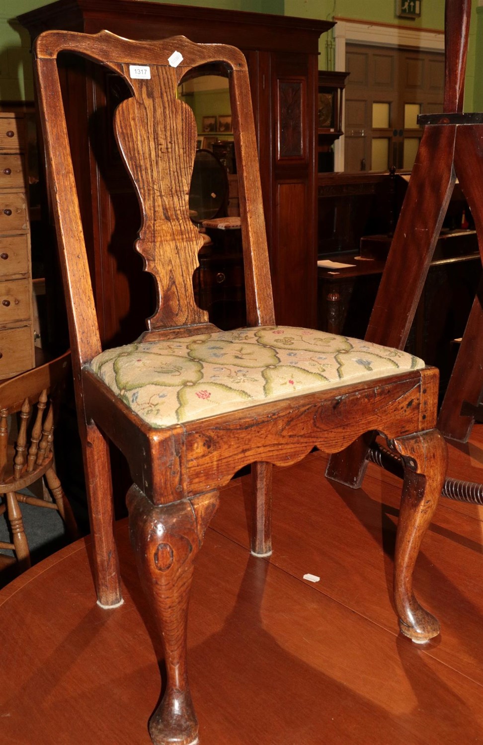 Lot 1317 - An early 18th century elm country chair,