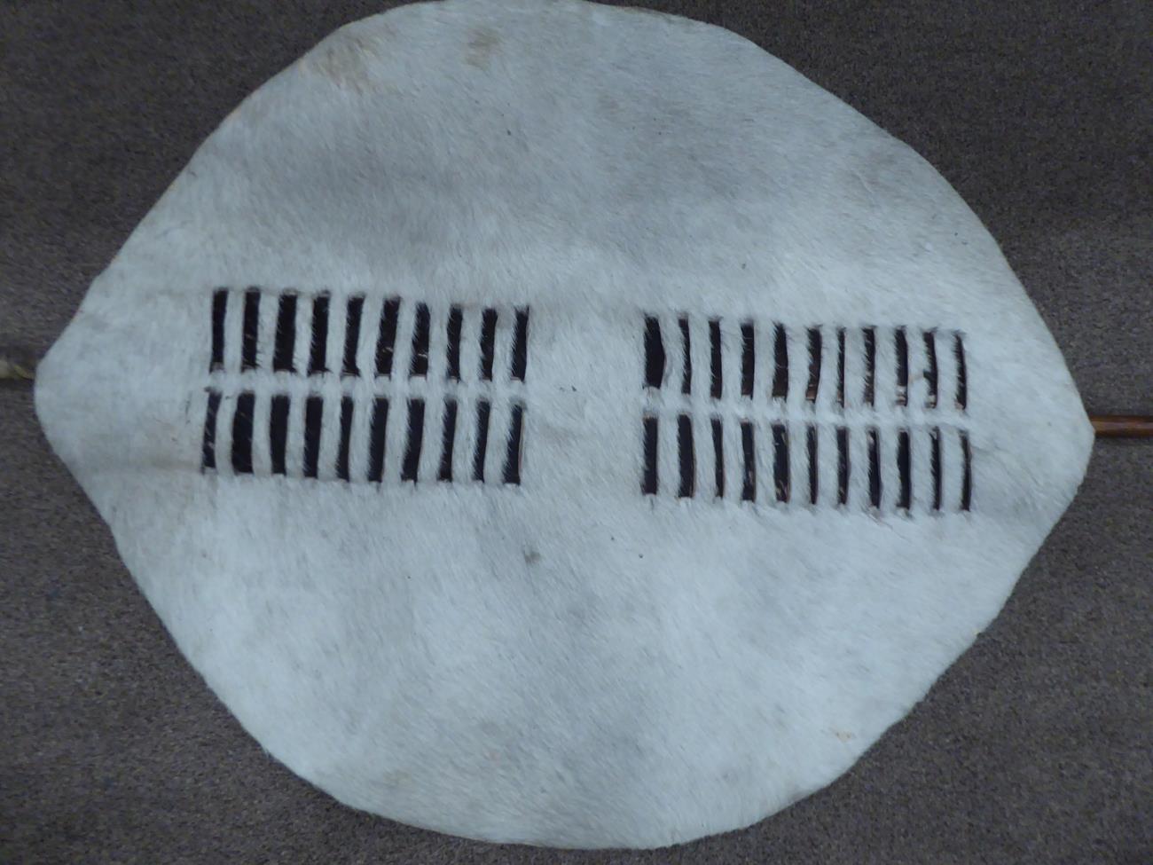 Lot 327 - A 20th Century Zulu White Cow Hide Shield,