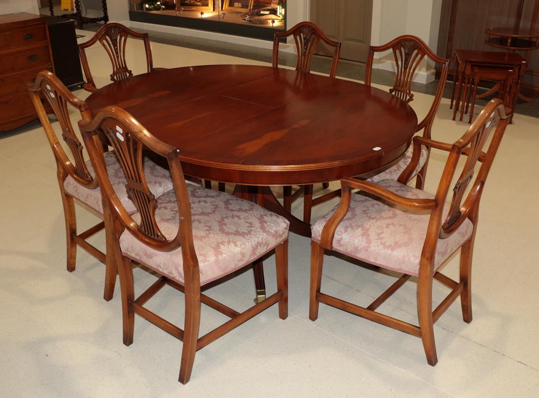 Lot 1224 - A yew wood veneered single pedestal dining