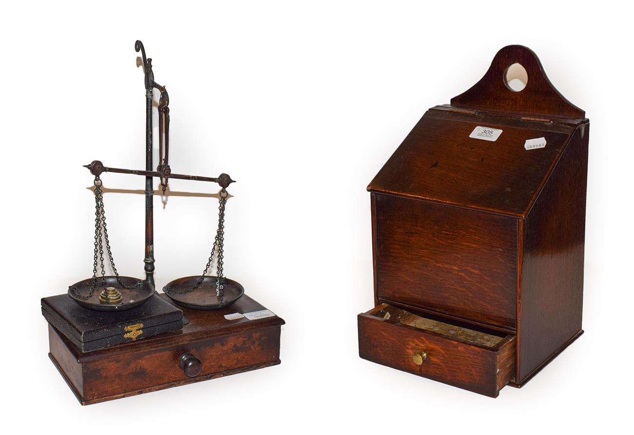Lot 305 - A Georgian oak wall mounting salt box with