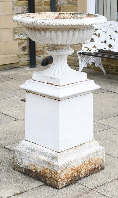 Lot 1343 - A white cast iron garden urn of fluted