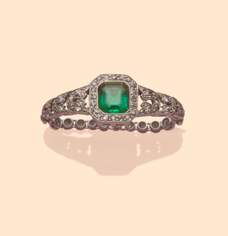 Lot 603 - An Emerald and Diamond Ring, the step-cut