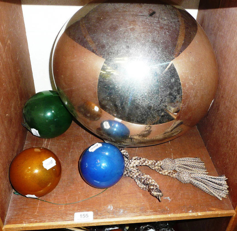 Lot 155 - A large glass witches ball and three small